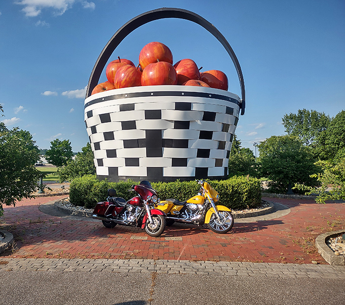 Even motorcycles look tiny beside this woven colossus. Bikers regularly make pilgrimages to this spot, proving the basket's appeal crosses all demographic boundaries.