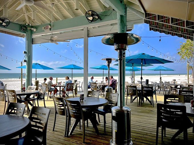 Dining with a view that makes you wonder why you ever eat indoors. Those blue umbrellas provide just enough shade to justify another hour of lunch.