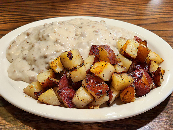 Biscuits and gravy alongside home fries&mdash;a breakfast so hearty it could fuel a tractor pull. That pepper-speckled gravy isn't just a topping; it's liquid comfort.