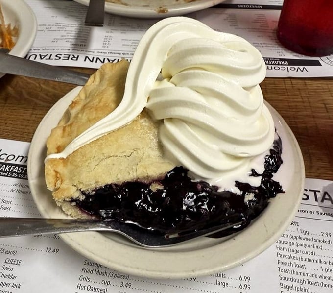 Berry pie that makes you question every dessert decision you've ever made. That mountain of whipped cream isn't compensation&mdash;it's celebration.