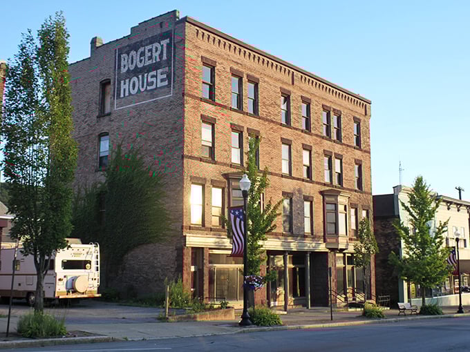 The Bogert House stands four stories tall, wearing its ghost sign like a vintage concert t-shirt.