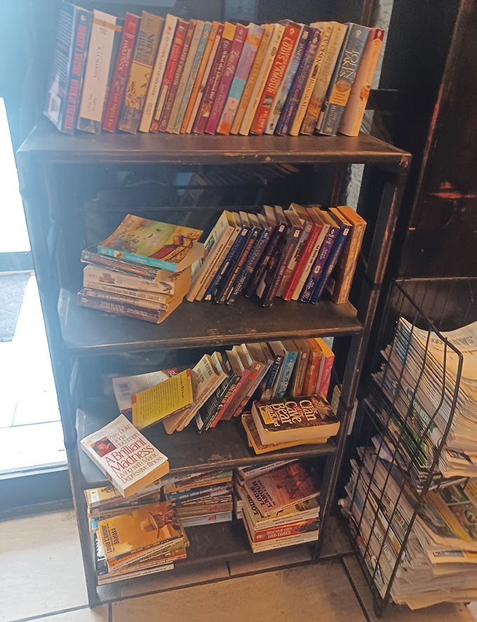 A bookshelf that invites you to linger after your meal. Trade paperbacks and trading recipes&mdash;both are community currencies here.