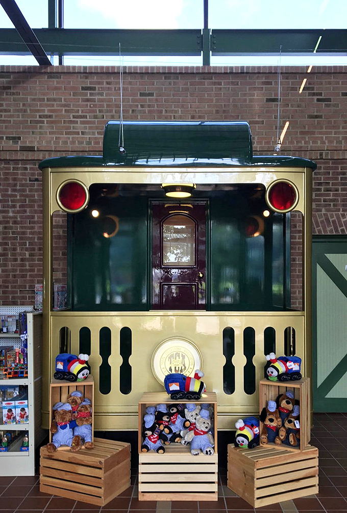 All aboard the gift shop express! This charming conductor's booth surrounded by plush companions invites visitors to take a piece of the magic home.