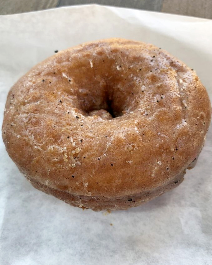 The humble donut, elevated to art form. This unglazed beauty proves sometimes the best accessory is confidence and a dusting of sugar.