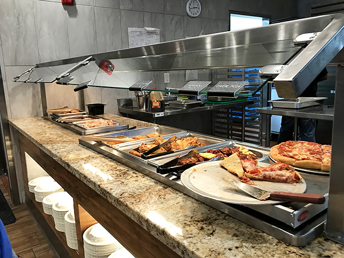 Hot food station featuring pizza and more &ndash; because sometimes you need a slice of comfort alongside your culinary adventure.