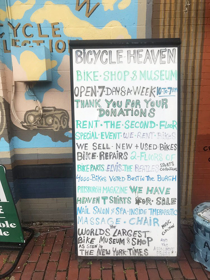 A hand-painted sign details the museum's offerings beyond bikes. The therapeutic massage chair mention suggests even the owner needs a break sometimes.