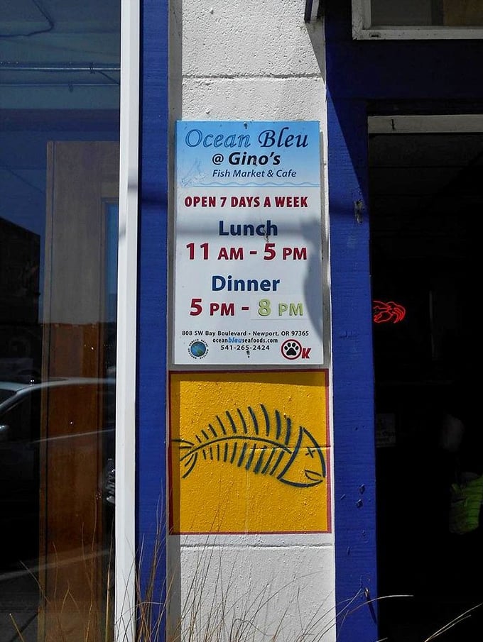 Business hours that respect the rhythms of coastal life. The fish skeleton painted below seems to say, "Trust me, it's worth planning your day around this place."