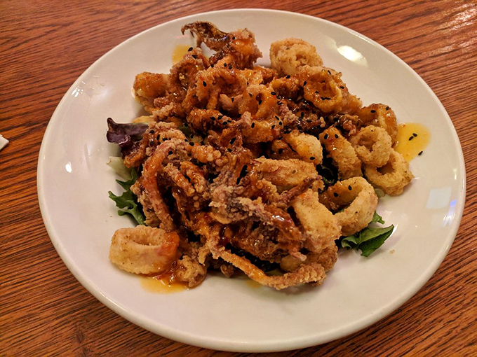 Crispy calamari that shatters with each bite, proving that sometimes the best things in life are simply fried to golden perfection.