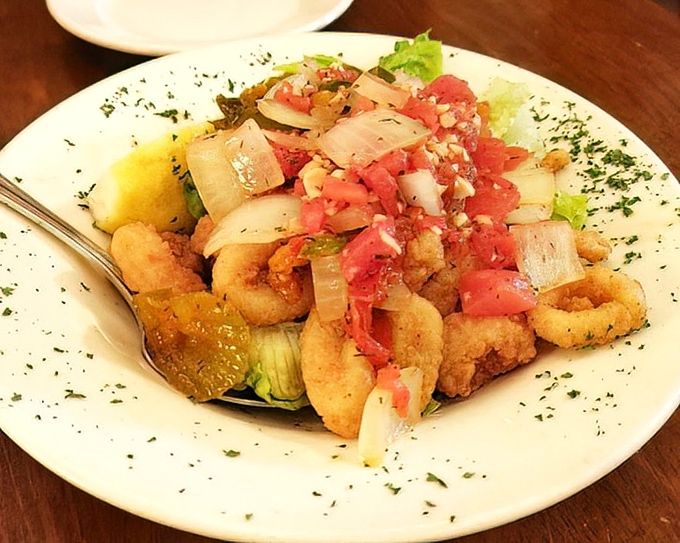 Calamari that doesn't know it's supposed to be rubbery. Instead, it's tender, golden, and topped with a fresh salsa that brightens every bite.