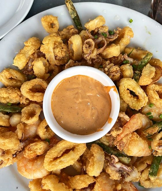 Crispy, golden calamari that would make Neptune himself swim to shore. That dipping sauce deserves its own fan club.