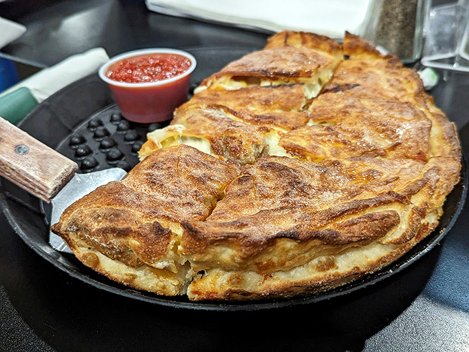 A calzone so perfectly golden it belongs in Fort Knox. That marinara dipping sauce is the key that unlocks the treasure.