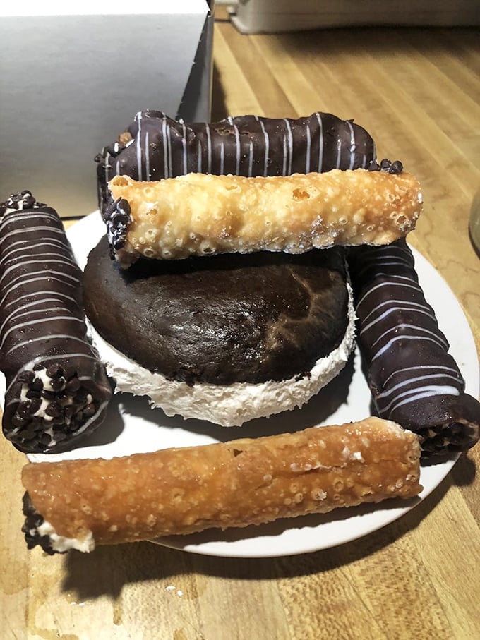 A plate of pure indulgence featuring chocolate-dipped cannolis and a whoopie pie. This is the dessert sampler of your dreams.