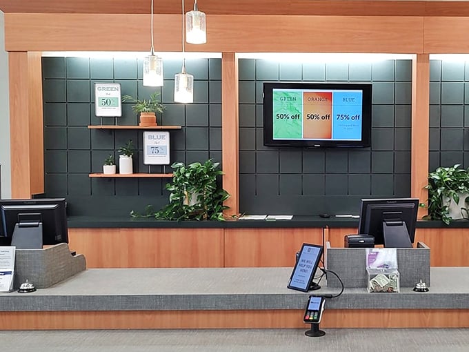 The modern checkout counter features digital displays showing today's color-coded discount system in action.