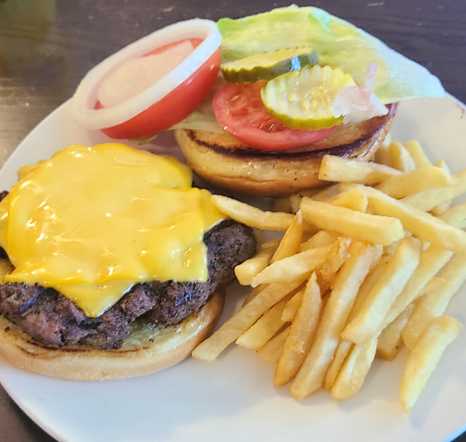 The cheeseburger that makes you question your loyalty to pulled pork. That perfect char, melty cheese, and golden fries form the holy trinity of comfort.