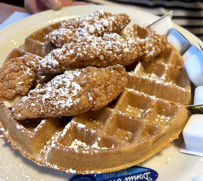 Chicken and waffles: the breakfast-meets-lunch romance that never gets old. That powdered sugar dusting is the culinary equivalent of fairy dust.
