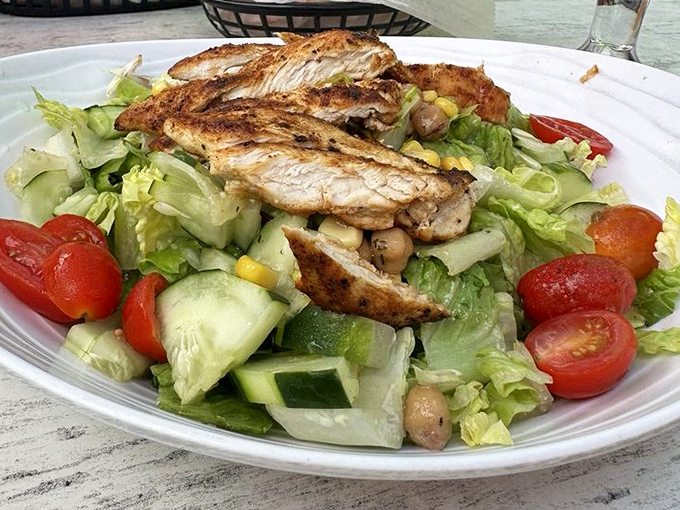 A salad that doesn't apologize for being healthy. Fresh greens supporting grilled chicken with the confidence of a Florida retiree who's found their perfect community.