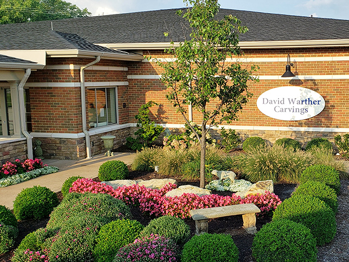 David Warther Carvings welcomes visitors with a garden so perfectly manicured it makes my attempts at landscaping look like I'm cultivating a wilderness preserve.