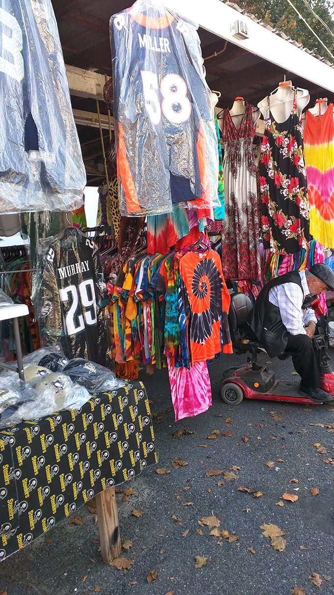 Vintage jerseys and tie-dye treasures hang like colorful flags celebrating decades of American fashion trends.