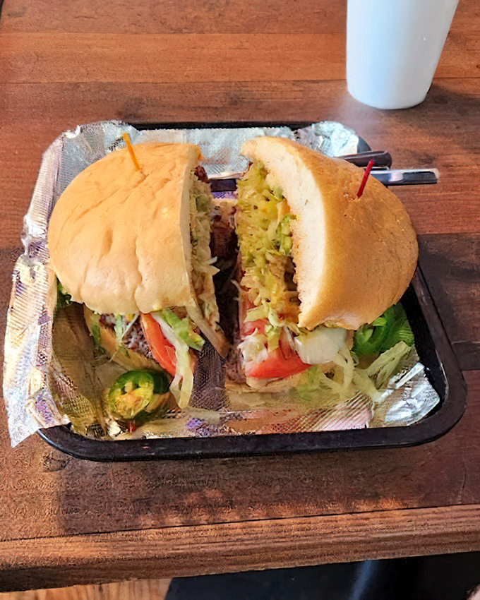 The cross-section reveals the truth: this sandwich is serious business. Fresh ingredients stacked with architectural precision.