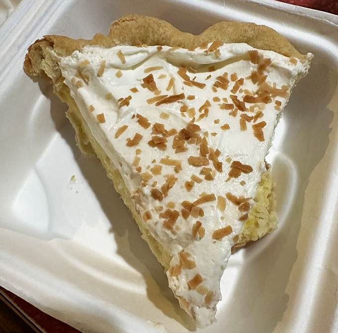 Coconut pie that whispers sweet nothings. That cloud-like whipped topping and toasted coconut flakes are what dessert dreams are made of.