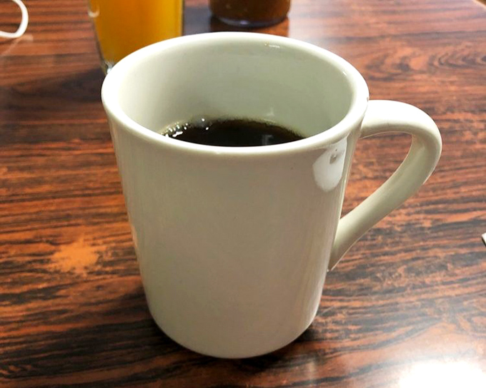 The humble diner coffee mug&mdash;holding the life-giving elixir that makes conversation possible before 10 AM. Simple, honest, and exactly what you need.