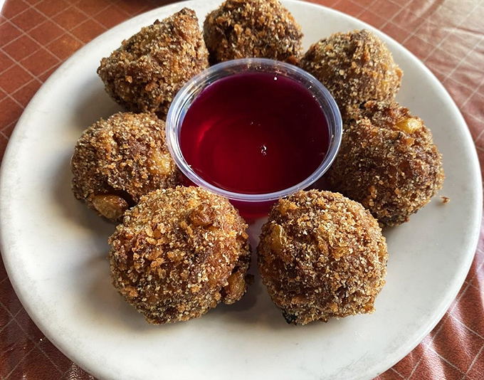 Corn fritters that look like they're auditioning for a role in your food dreams, with a dipping sauce that seals the deal.