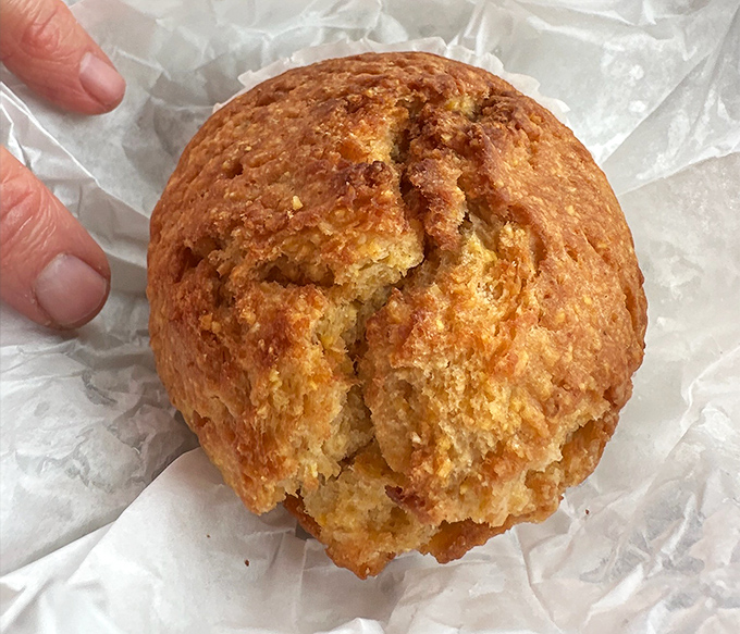 This cornbread muffin has the perfect crack on top&mdash;nature's way of telling you it's done right. Golden, crumbly perfection waiting for your first bite.
