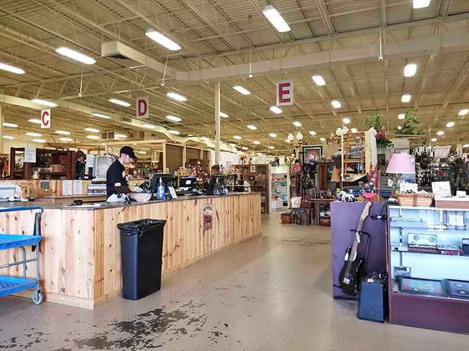 The command center of treasure hunting operations, where friendly staff turn your discoveries into take-home memories. Section letters overhead guide the adventure.