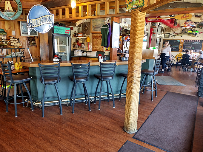 The Blue Moon sign watches over a bar where locals and visitors alike find common ground in their appreciation for fresh catch.