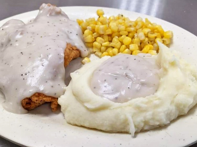 Country fried steak swimming in pepper gravy alongside mashed potatoes that clearly never came from a box. This plate is Southern comfort defined.