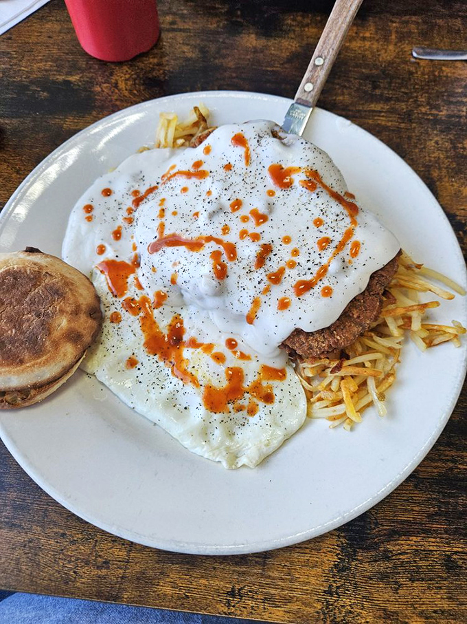 Country fried steak smothered in gravy with eggs on top&mdash;a breakfast so hearty it could fuel a marathon or cure what ailed you last night.