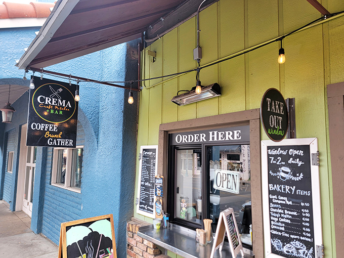 Crema Craft Kitchen's cheerful blue exterior houses coffee magic and bakery treasures. Order at the window, then savor every bite like a local.