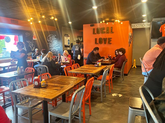 The "LOCAL LOVE" wall isn't just Instagram bait&mdash;it's the restaurant's philosophy in two words. Orange chairs invite you to be part of the family.
