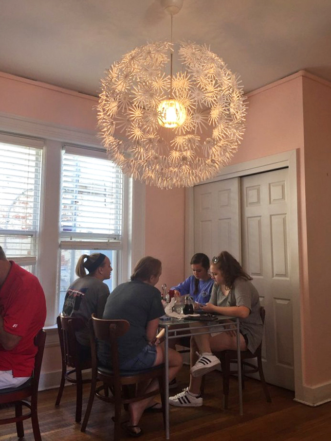 Under a whimsical dandelion-inspired light fixture, breakfast conversations flow as freely as the coffee, creating memories that last longer than the meal itself.