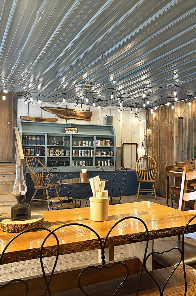 String lights cast a warm glow over live-edge tables, creating an atmosphere where comfort food meets comfort seating in perfect harmony.