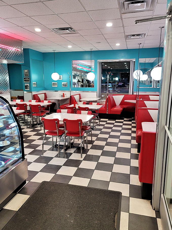 The classic black and white checkered floor sets the stage for breakfast theater. Red booths and globe lights create the perfect diner tableau.