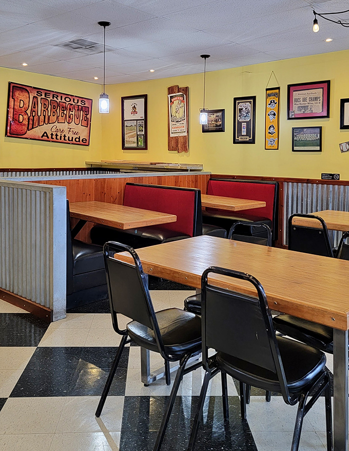 Red booths against corrugated metal with a "Serious Barbecue" sign overhead&mdash;they're not just feeding you, they're setting a mood.