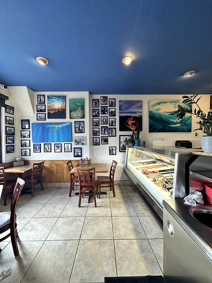 The dining room's blue ceiling and wave artwork create an underwater vibe. It's like eating in Neptune's casual dining room, where fishing photos replace family portraits.