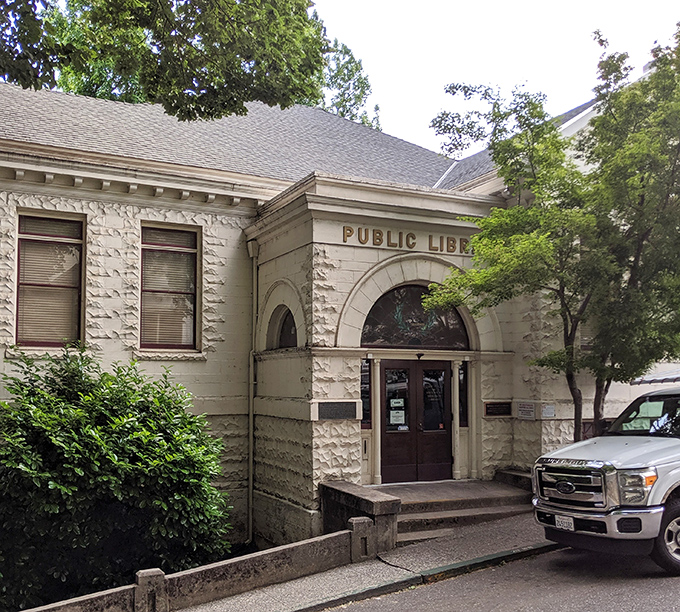 Nevada City&rsquo;s historic library welcomes visitors with timeless charm, inviting book lovers to explore stories within its peaceful, tree-lined setting.