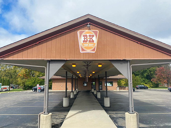The covered walkway isn't just architectural—it's an invitation to experience food the way Americans have for generations: sometimes in your car.