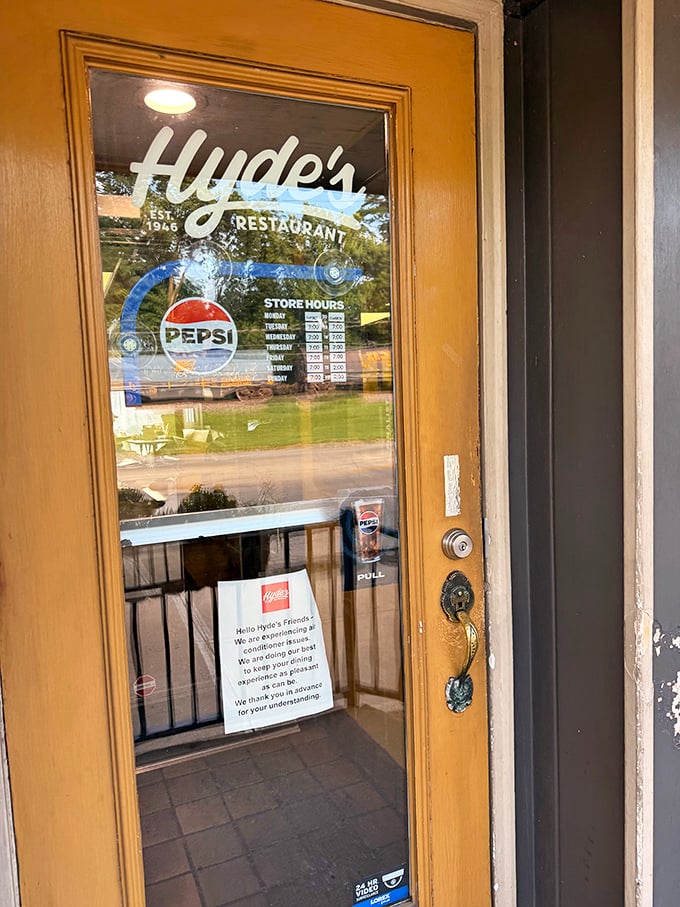 The entrance door with its vintage lettering and posted hours feels like a portal to a time when restaurants were the heart of small-town America.