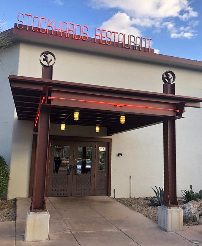 The neon sign glows like a beacon for meat lovers as dusk falls over Phoenix. A portal to prime rib paradise.
