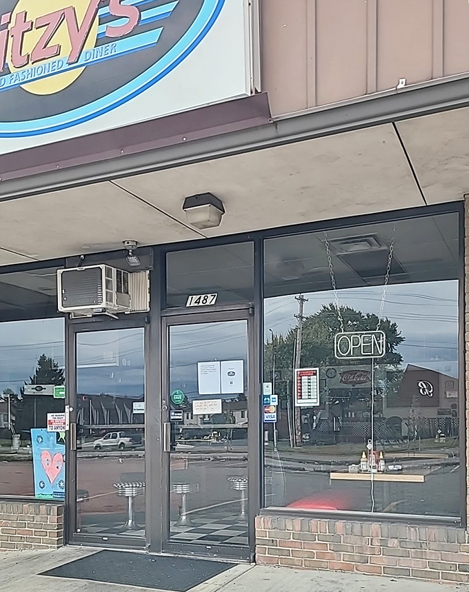 The entrance to breakfast paradise, complete with that iconic neon "OPEN" sign that beckons like a lighthouse for the hungry.