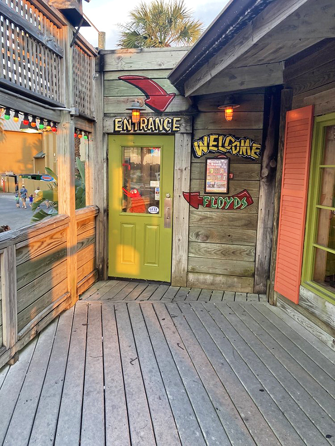 The lime-green entrance door pops against weathered wood, a cheerful portal to seafood paradise that screams "vacation starts here!"