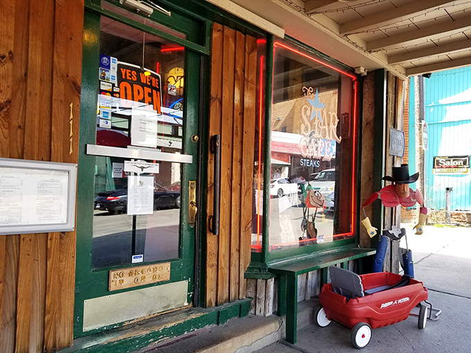 The entrance says everything you need to know: unpretentious, welcoming, and with a little red wagon that suggests kids are as welcome as cowboys.