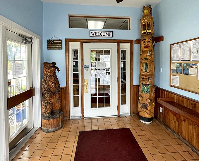 Flanked by a carved bear and totem pole, this entrance says "Welcome to the North" better than any travel brochure ever could.