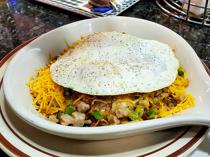 The Farmer's Skillet&mdash;where breakfast ingredients have a party under a perfectly fried egg roof, with cheese playing the role of welcome guest.