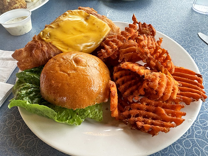 A perfectly golden burger with sweet potato waffle fries that makes you question why you ever considered ordering seafood in the first place.