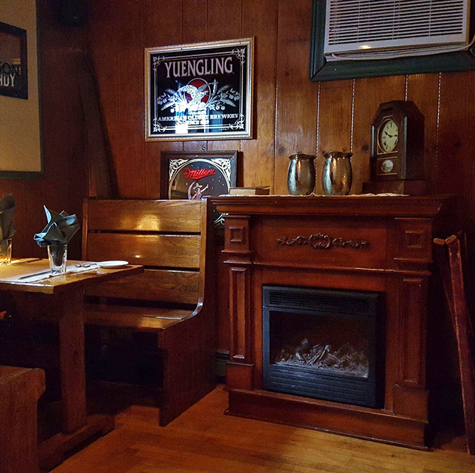 A corner fireplace flanked by Yuengling memorabilia &ndash; the perfect spot to contemplate whether you have room for that homemade cheesecake.