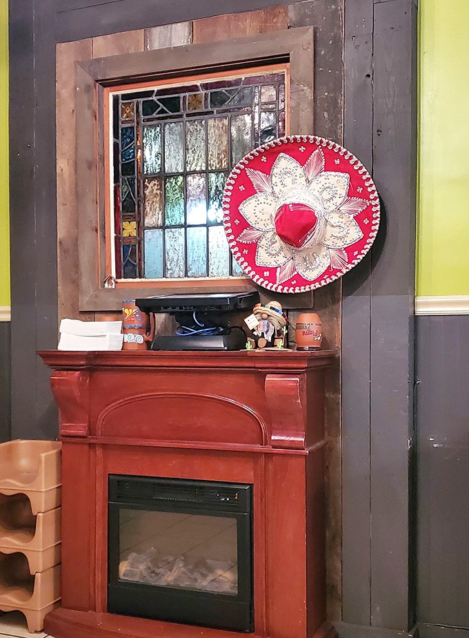 That decorative sombrero and stained glass window transform a simple fireplace into a warm, cultural embrace.